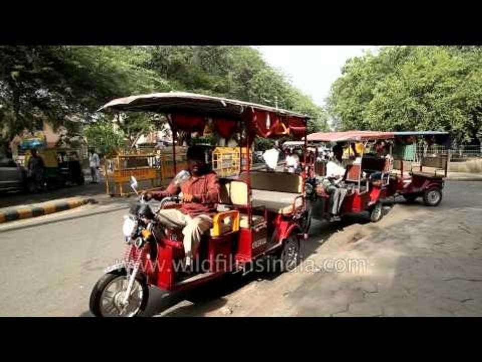 Electric rickshawala waiting for passengers in bright sun light - video ...