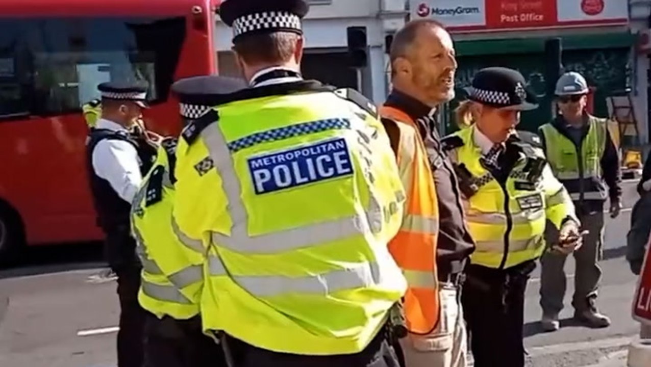 Police handcuff reverend as Just Stop Oil activists slow march through ...