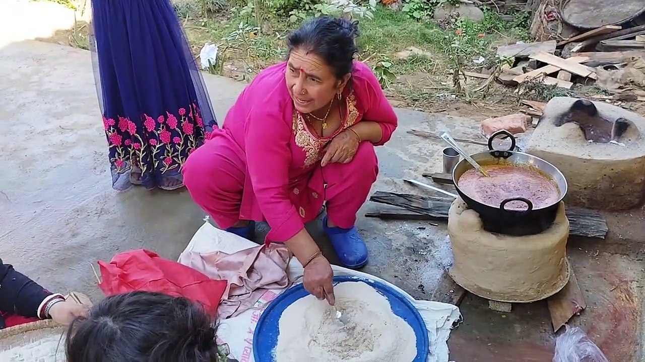 village women making traditional sweets with flour and sugar with hand ...