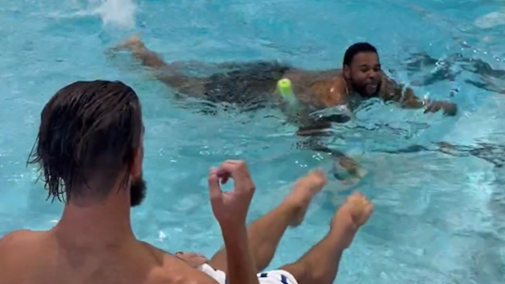 Michael Phelps teaching Travis Jones how to swim with the help of a ...