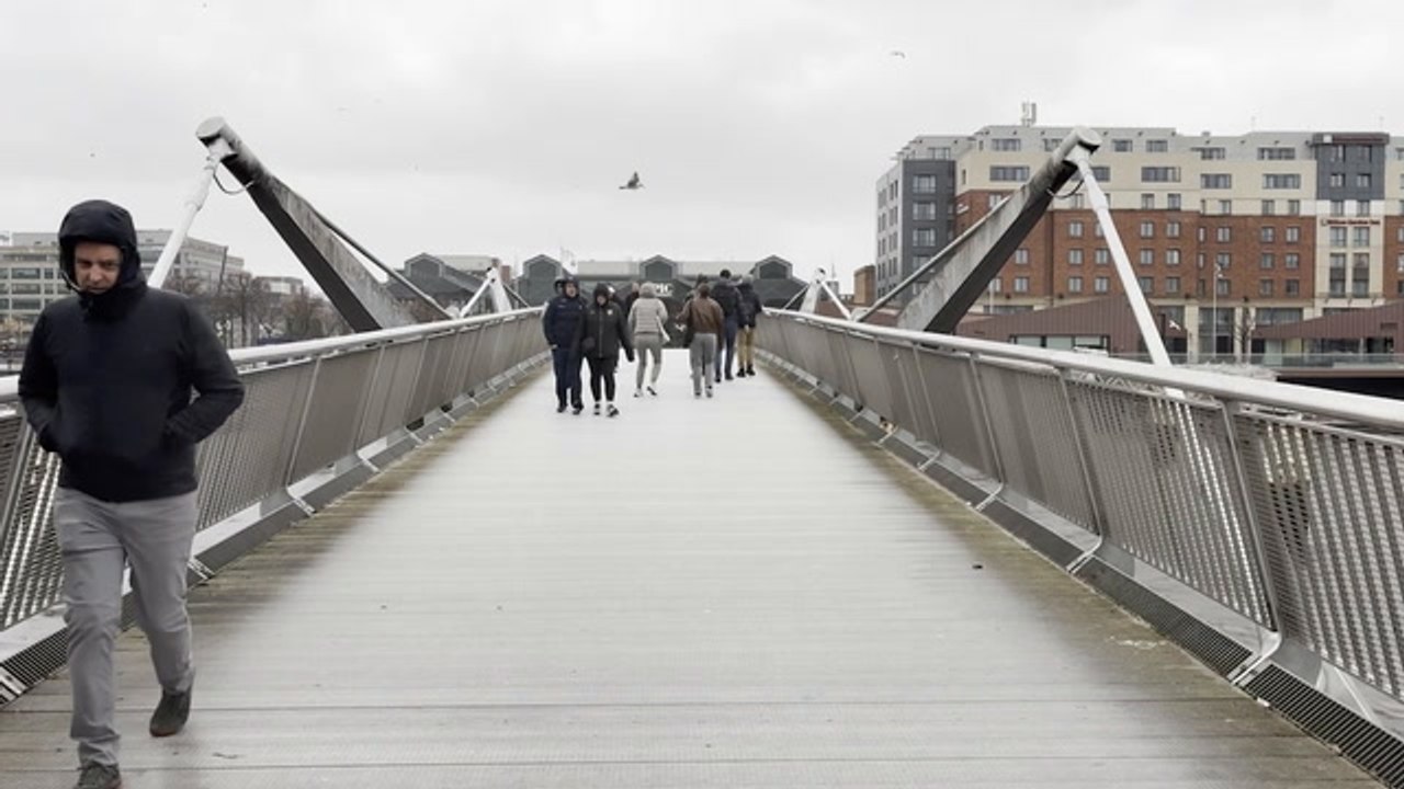 People cross Sean O'Casey bridge as storm Claudia expected to dump month's worth of rain on ...